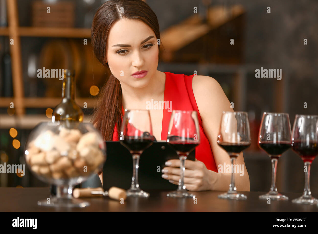 Female sommelier working in wine cellar Stock Photo - Alamy