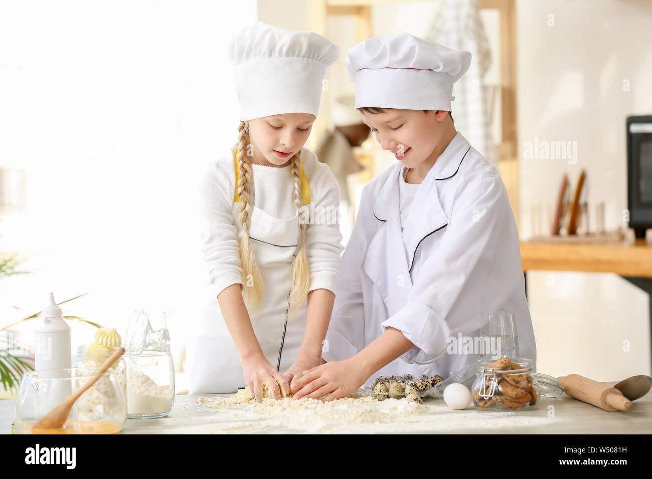 Cute little chefs cooking in kitchen Stock Photo - Alamy
