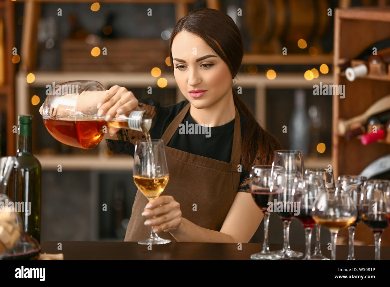 Female sommelier working in wine cellar Stock Photo - Alamy