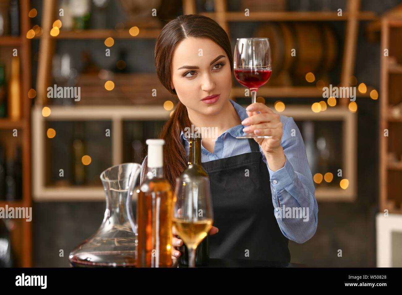 Female sommelier working in wine cellar Stock Photo - Alamy