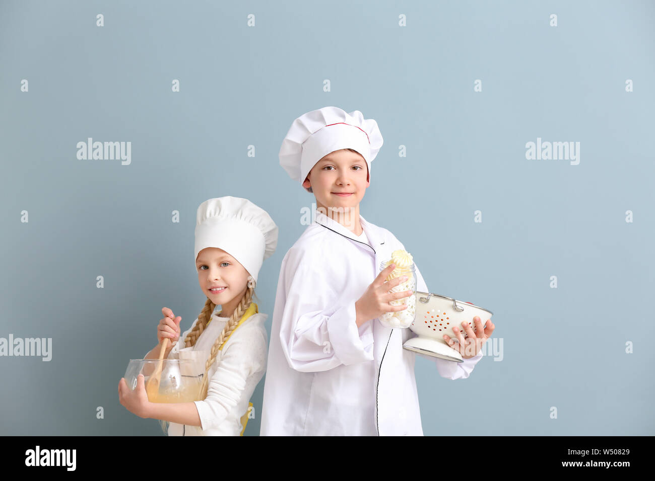 Cute little chefs on color background Stock Photo - Alamy