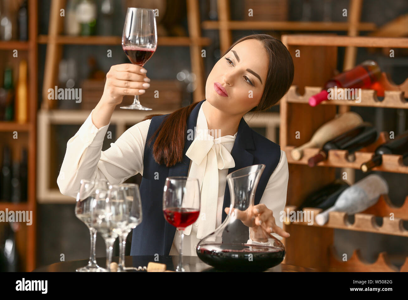 Female sommelier working in wine cellar Stock Photo - Alamy