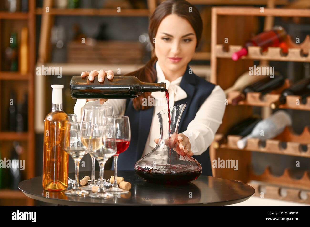 Female sommelier working in wine cellar Stock Photo - Alamy