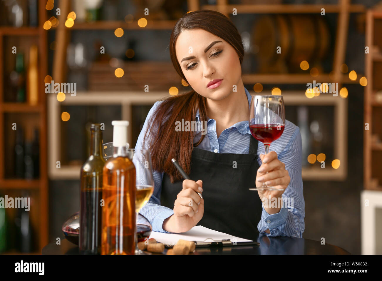 Female sommelier working in wine cellar Stock Photo - Alamy