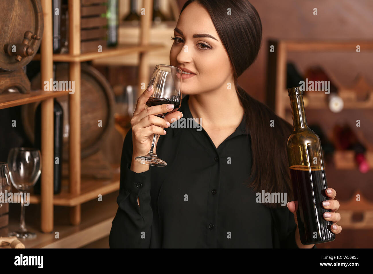 Female sommelier working in wine cellar Stock Photo - Alamy