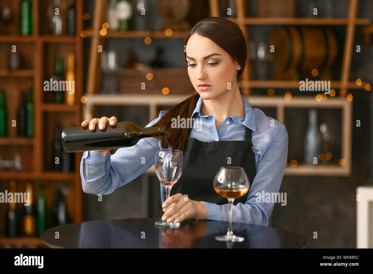 Female sommelier working in wine cellar Stock Photo - Alamy