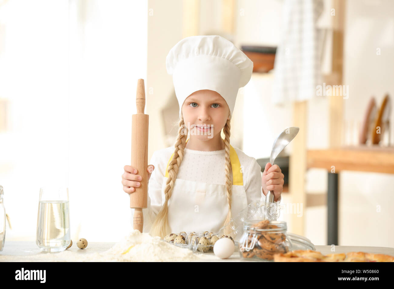 Cute little chef cooking in kitchen Stock Photo - Alamy