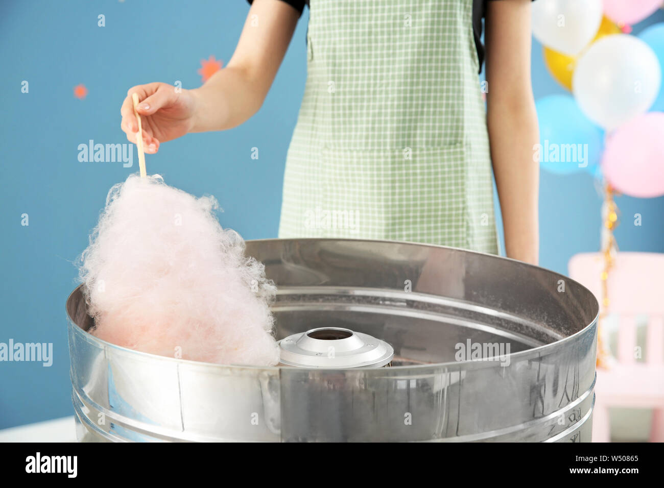 Woman making cotton candy at fair Stock Photo - Alamy