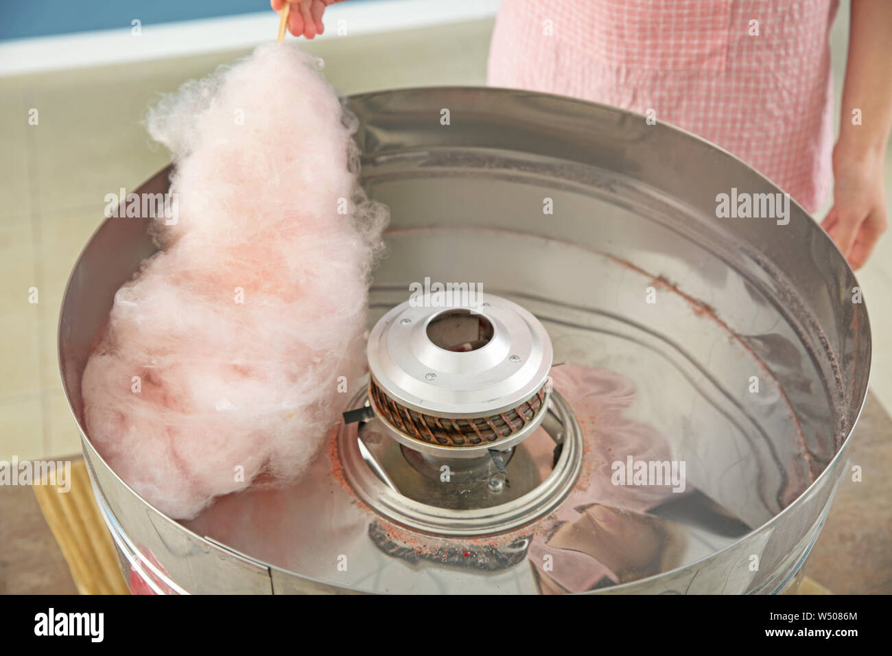 Woman making cotton candy at fair Stock Photo - Alamy