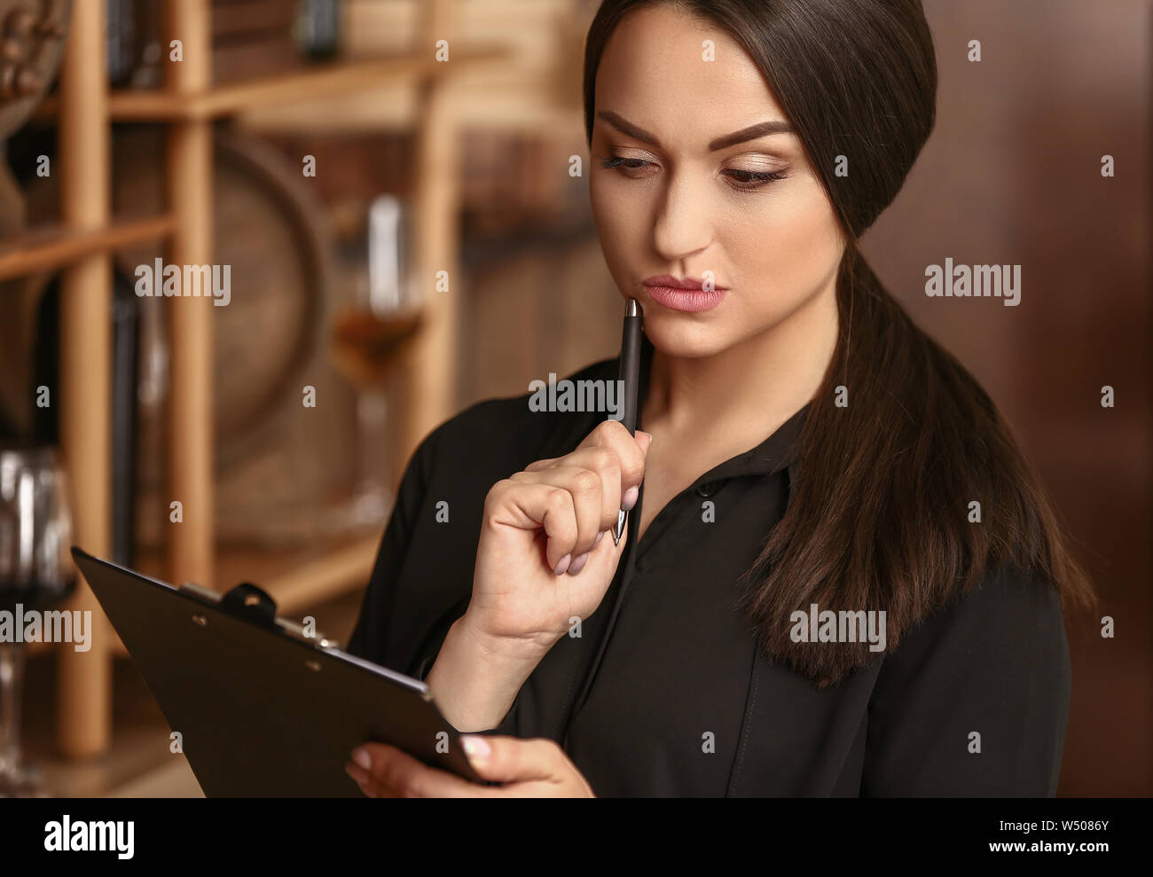 Female sommelier working in wine cellar Stock Photo - Alamy