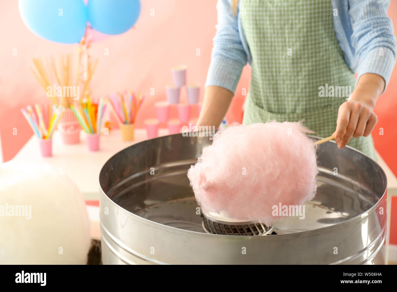 Woman making cotton candy at fair Stock Photo - Alamy