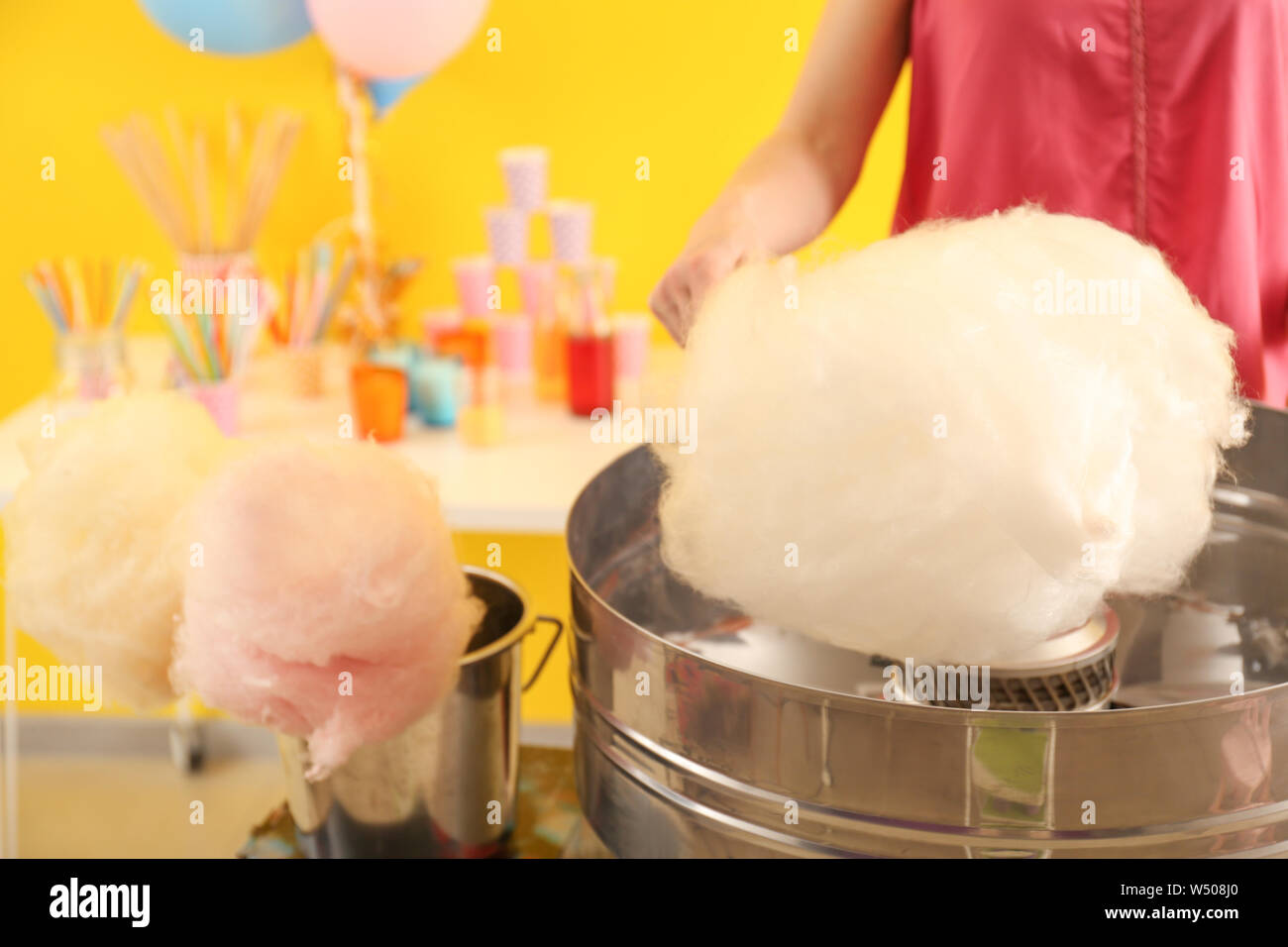 Woman making cotton candy at fair Stock Photo - Alamy