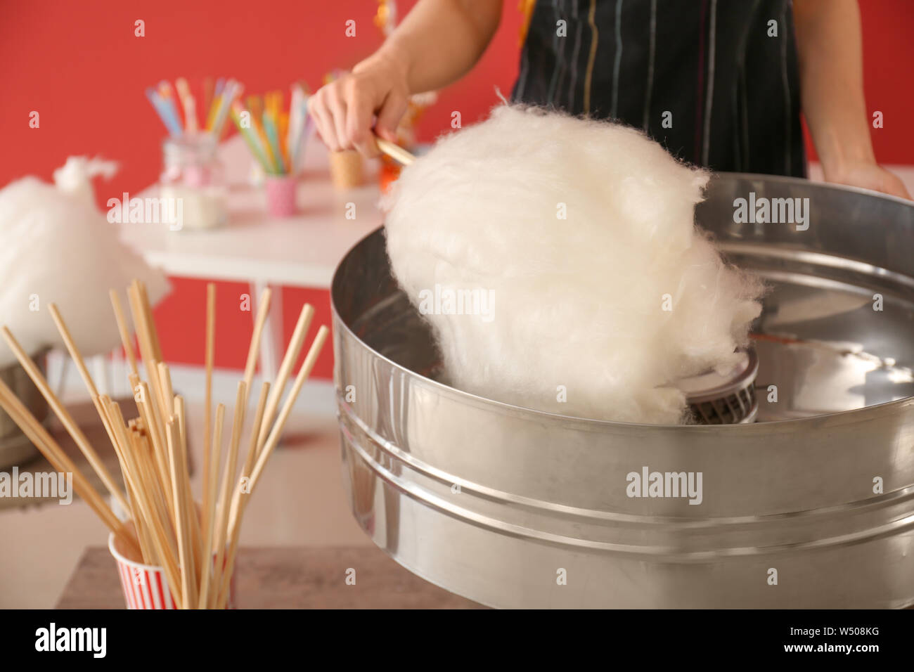 Woman making cotton candy at fair Stock Photo - Alamy
