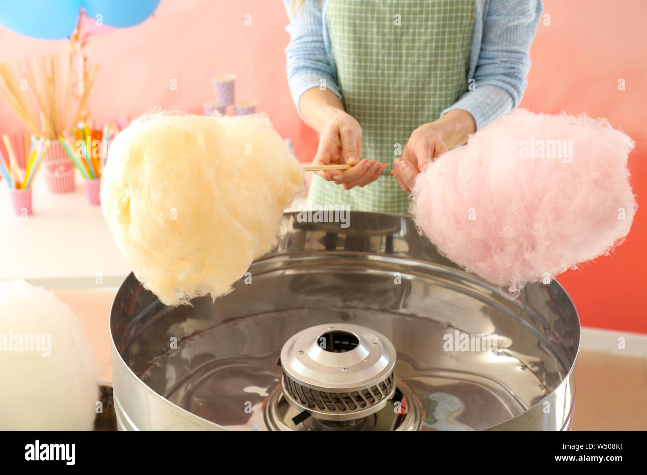Woman making cotton candy at fair Stock Photo - Alamy