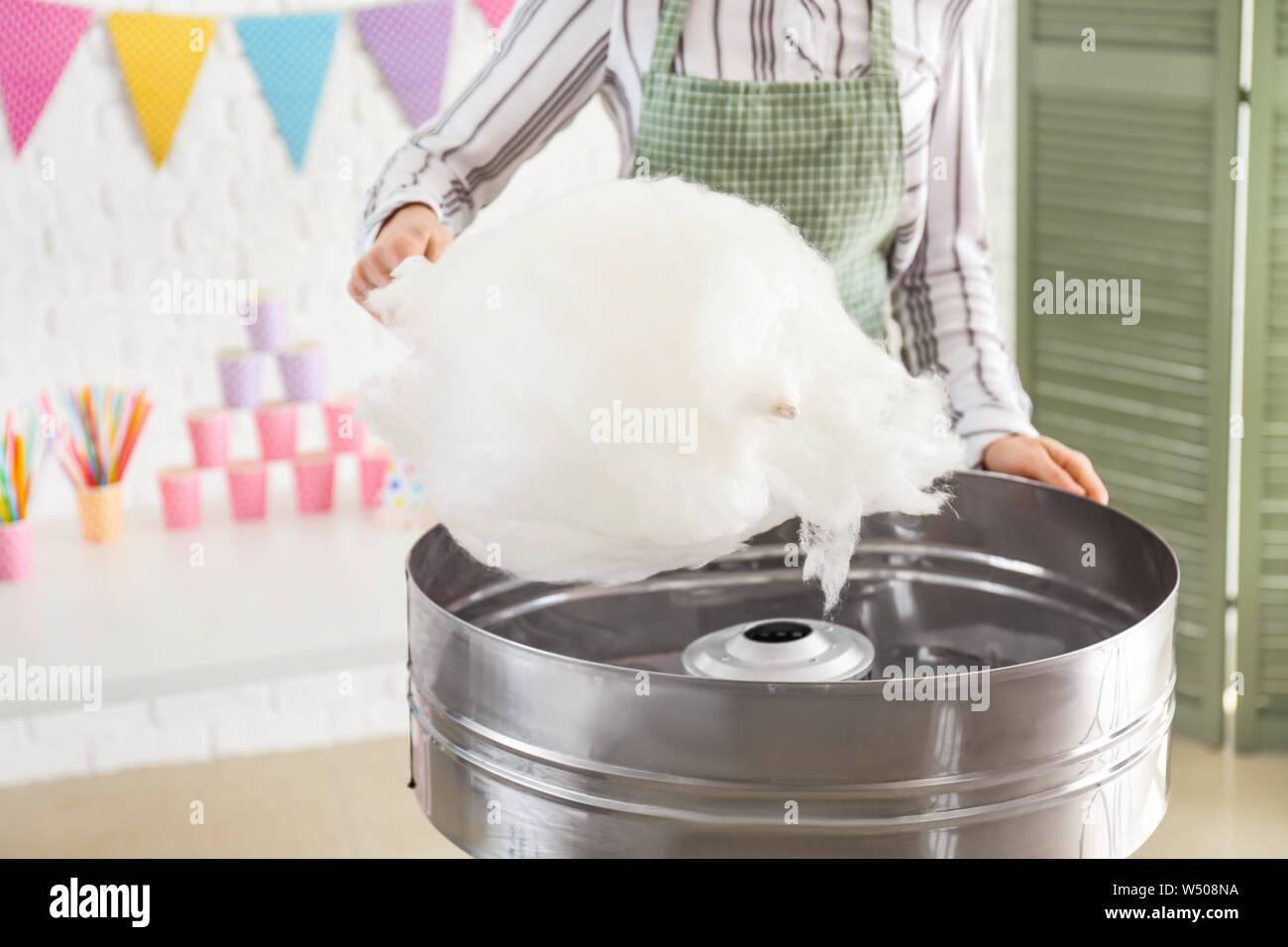Woman making cotton candy at fair Stock Photo - Alamy