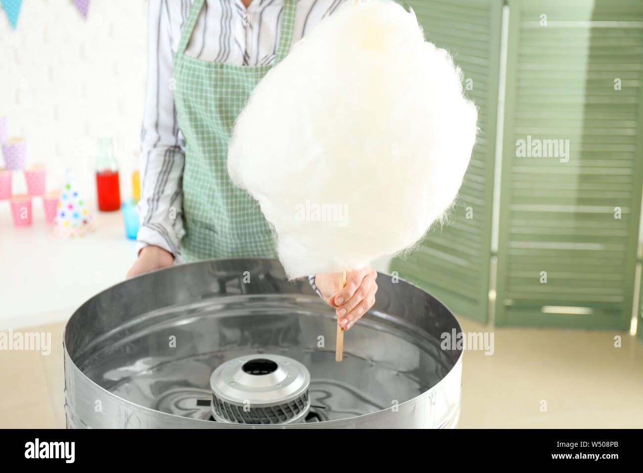 Woman making cotton candy at fair Stock Photo - Alamy