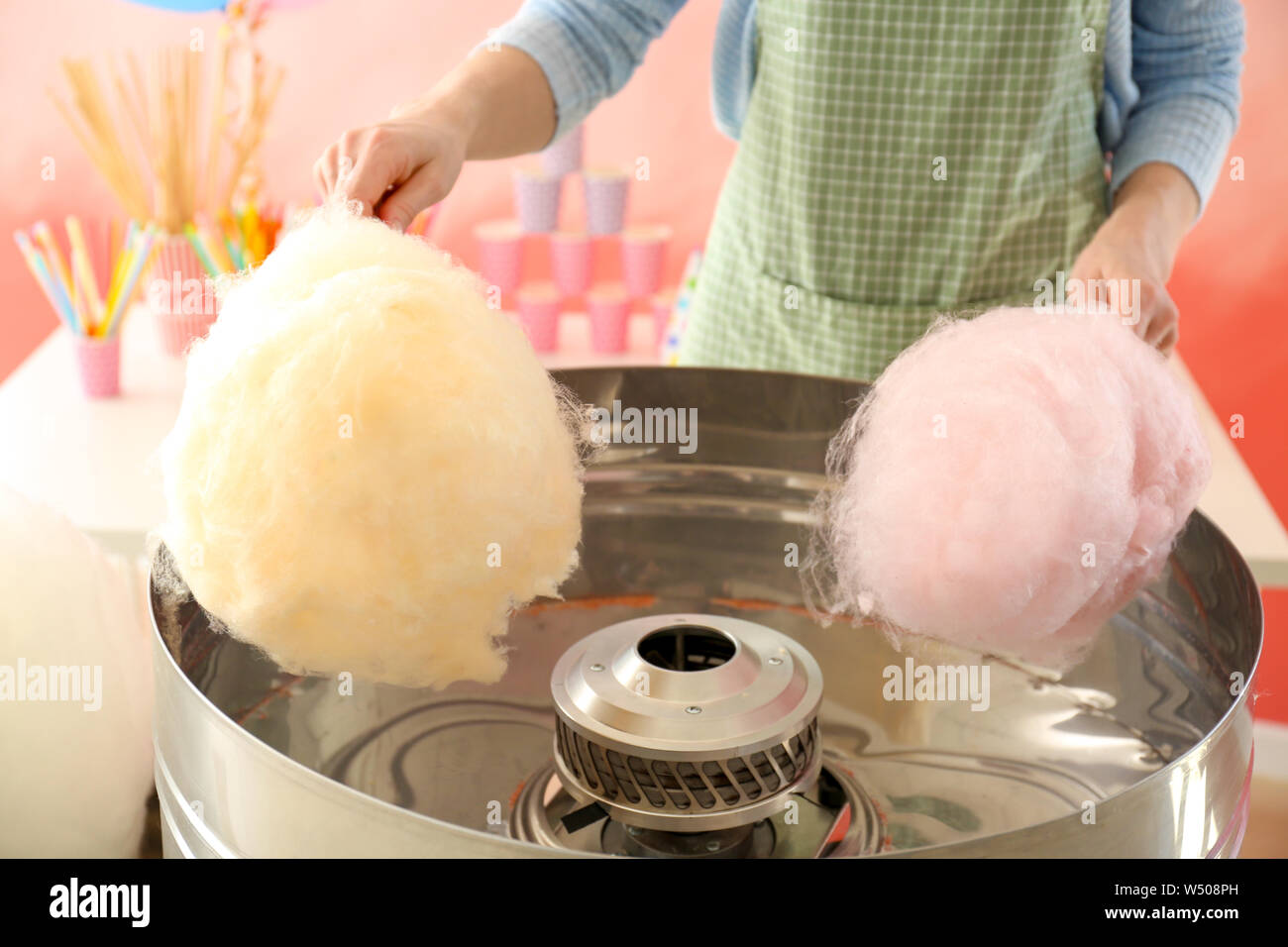 Woman making cotton candy at fair Stock Photo - Alamy