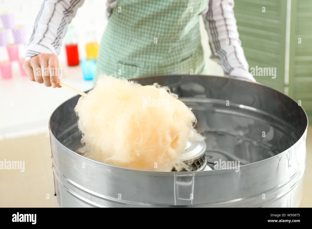 Woman making cotton candy at fair Stock Photo - Alamy