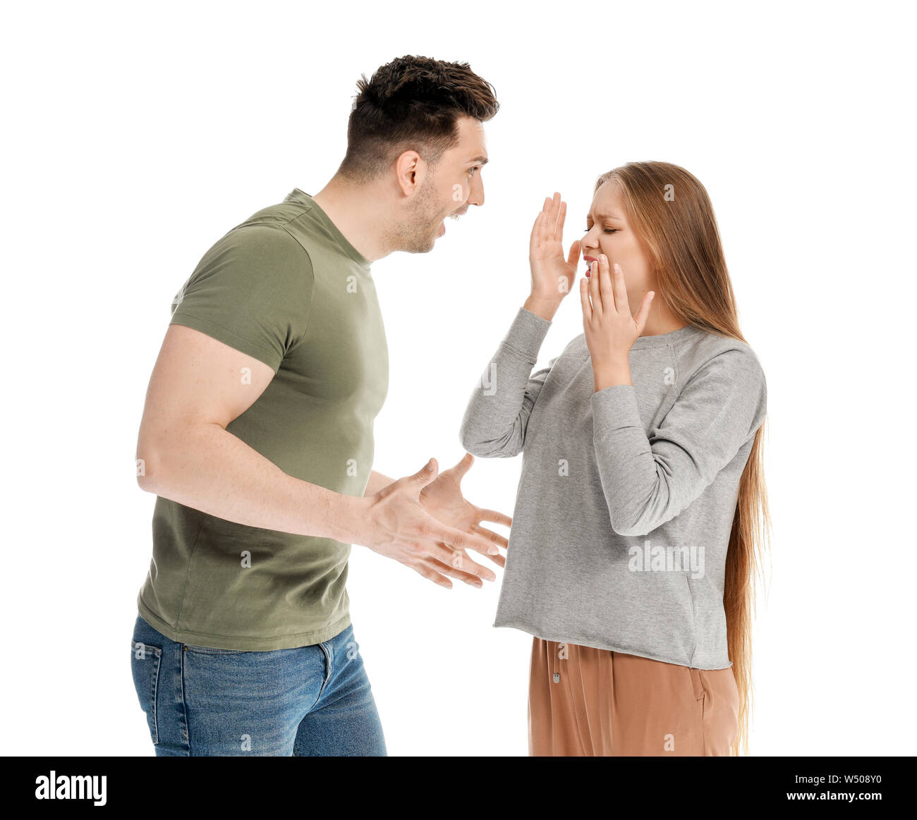 Young quarrelling couple on white background Stock Photo - Alamy