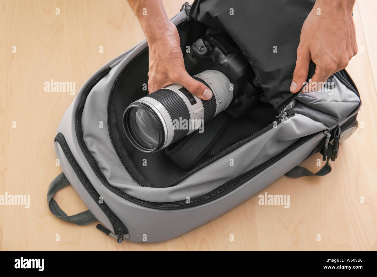 Male photographer putting camera hi-res stock photography and images ...