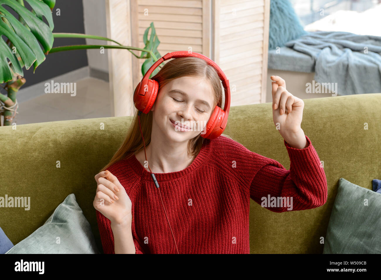 Cute teenage girl listening to music at home Stock Photo - Alamy