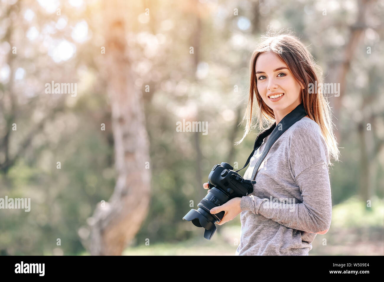 Beautiful female photographer working outdoors Stock Photo - Alamy