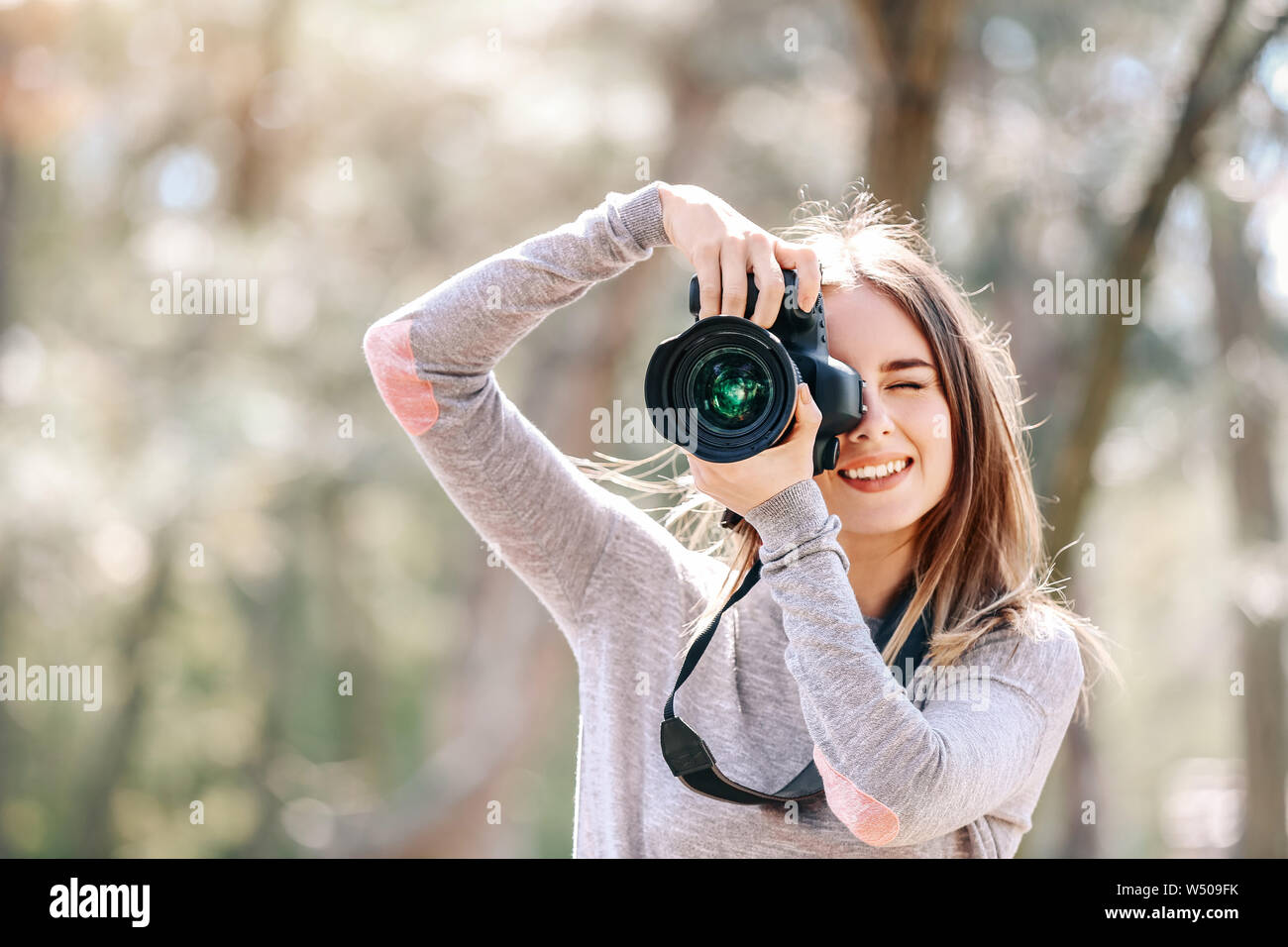 Beautiful female photographer working outdoors Stock Photo - Alamy