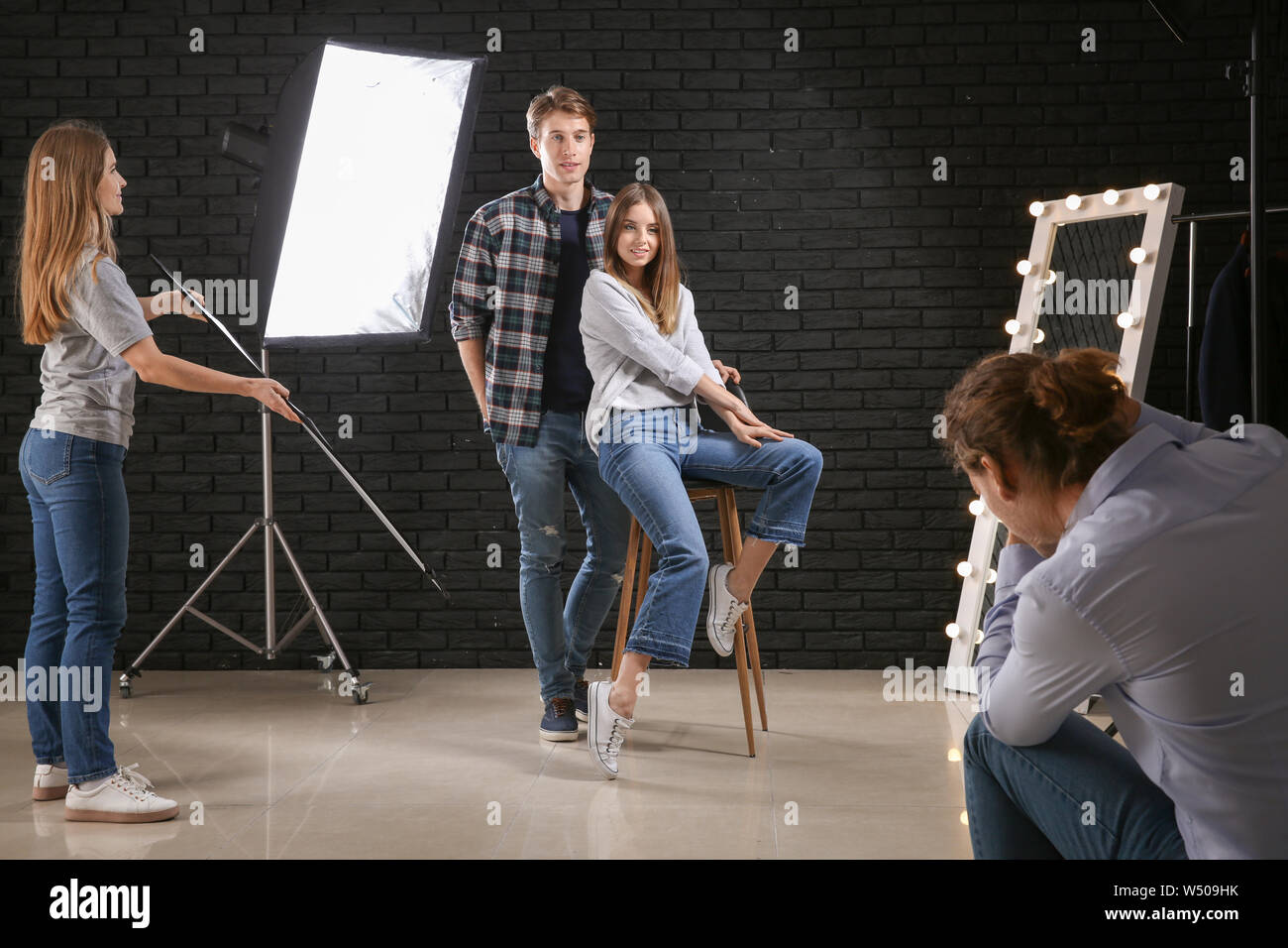 Professional photographer working with models in studio Stock Photo - Alamy