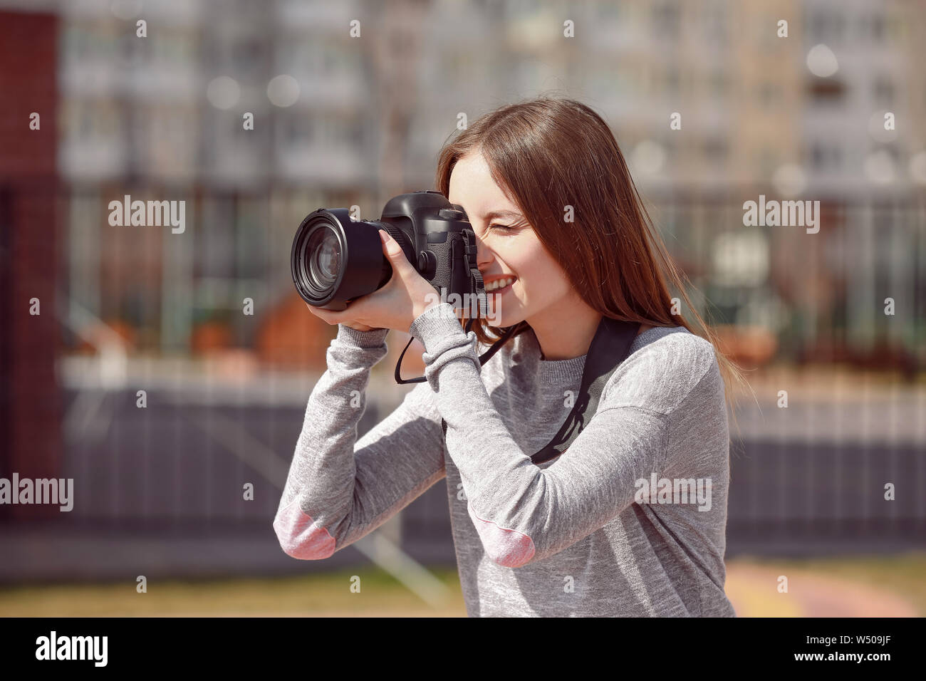 Beautiful female photographer working outdoors Stock Photo - Alamy