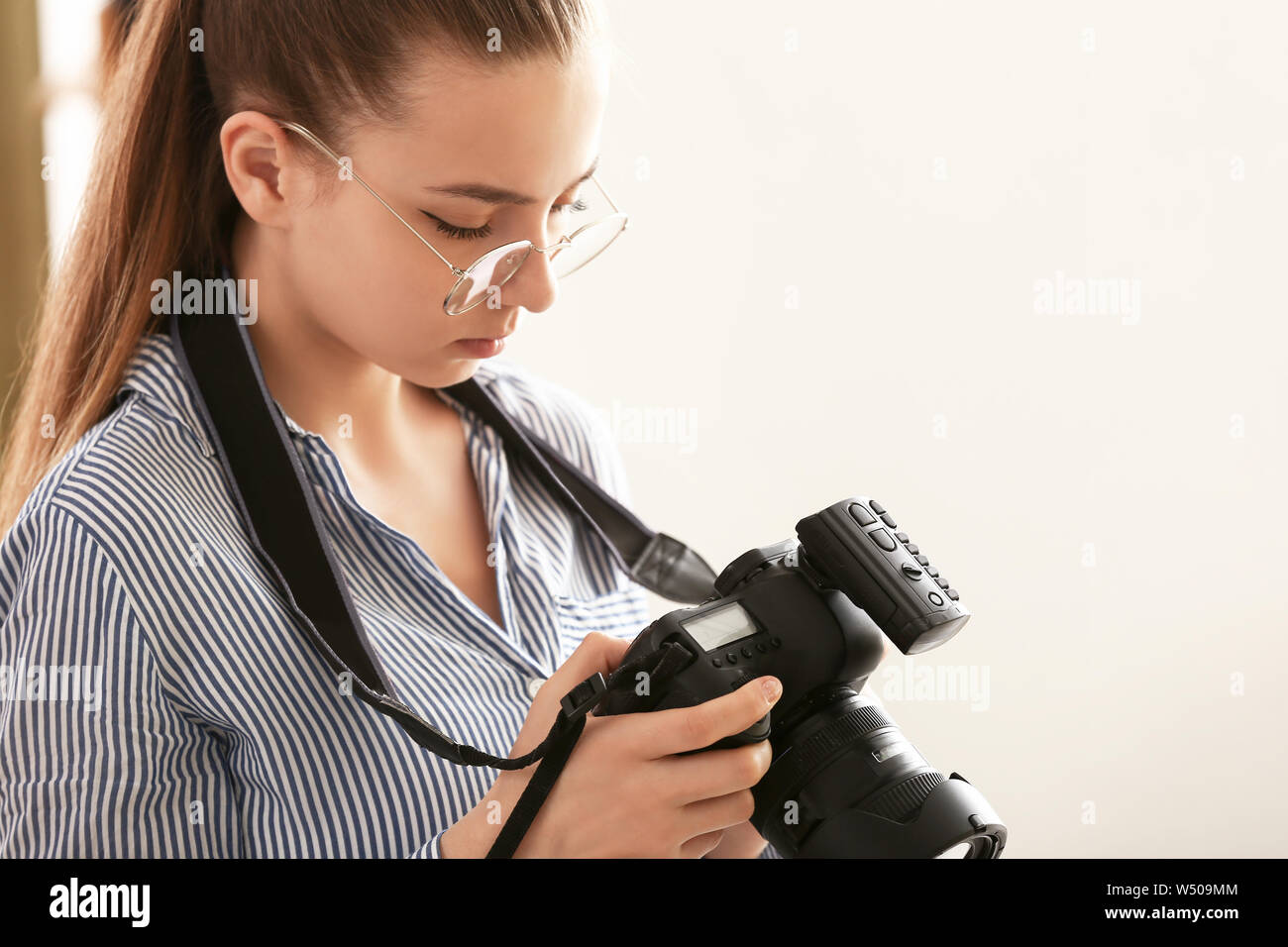 Teenage girl with photo camera at home Stock Photo - Alamy