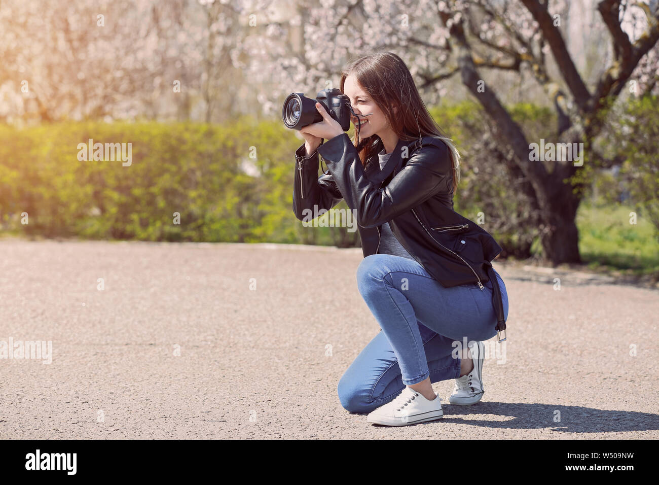 Beautiful female photographer working outdoors Stock Photo - Alamy
