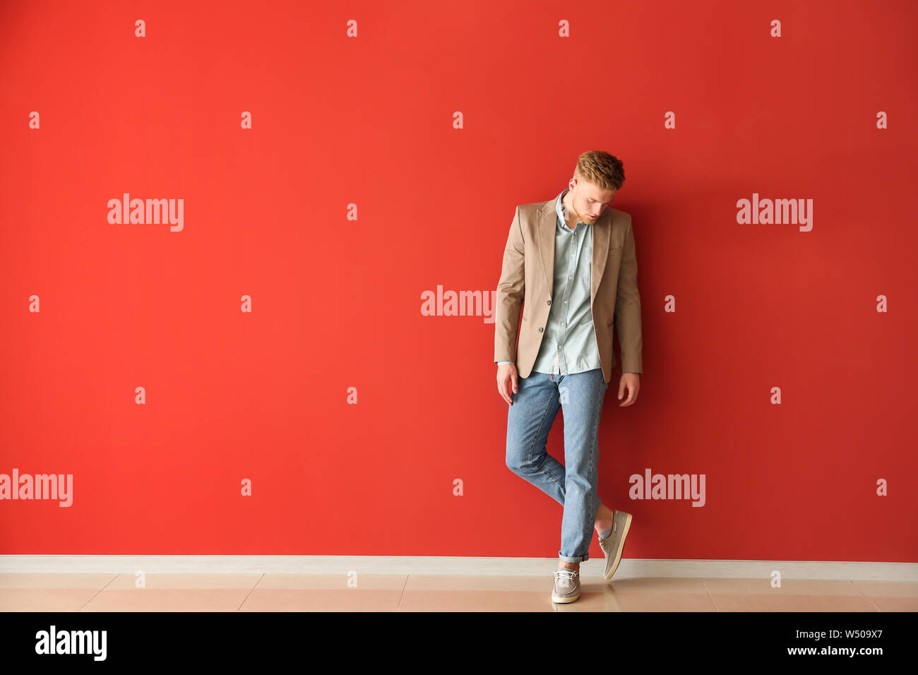 Young man posing near red hi-res stock photography and images - Alamy