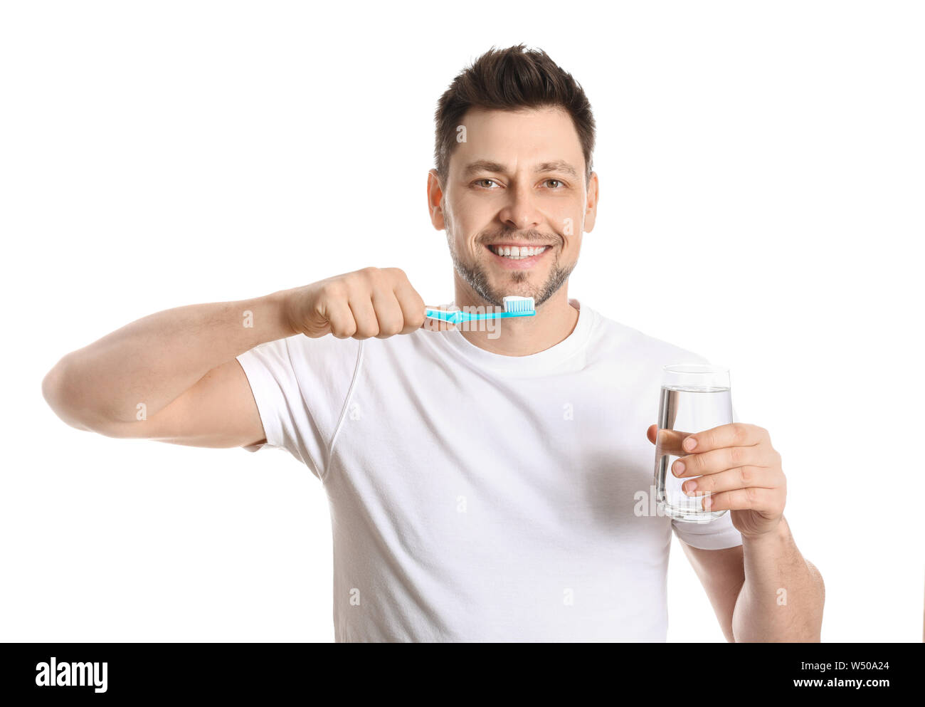 Man with toothbrush and glass of water on white background Stock Photo ...