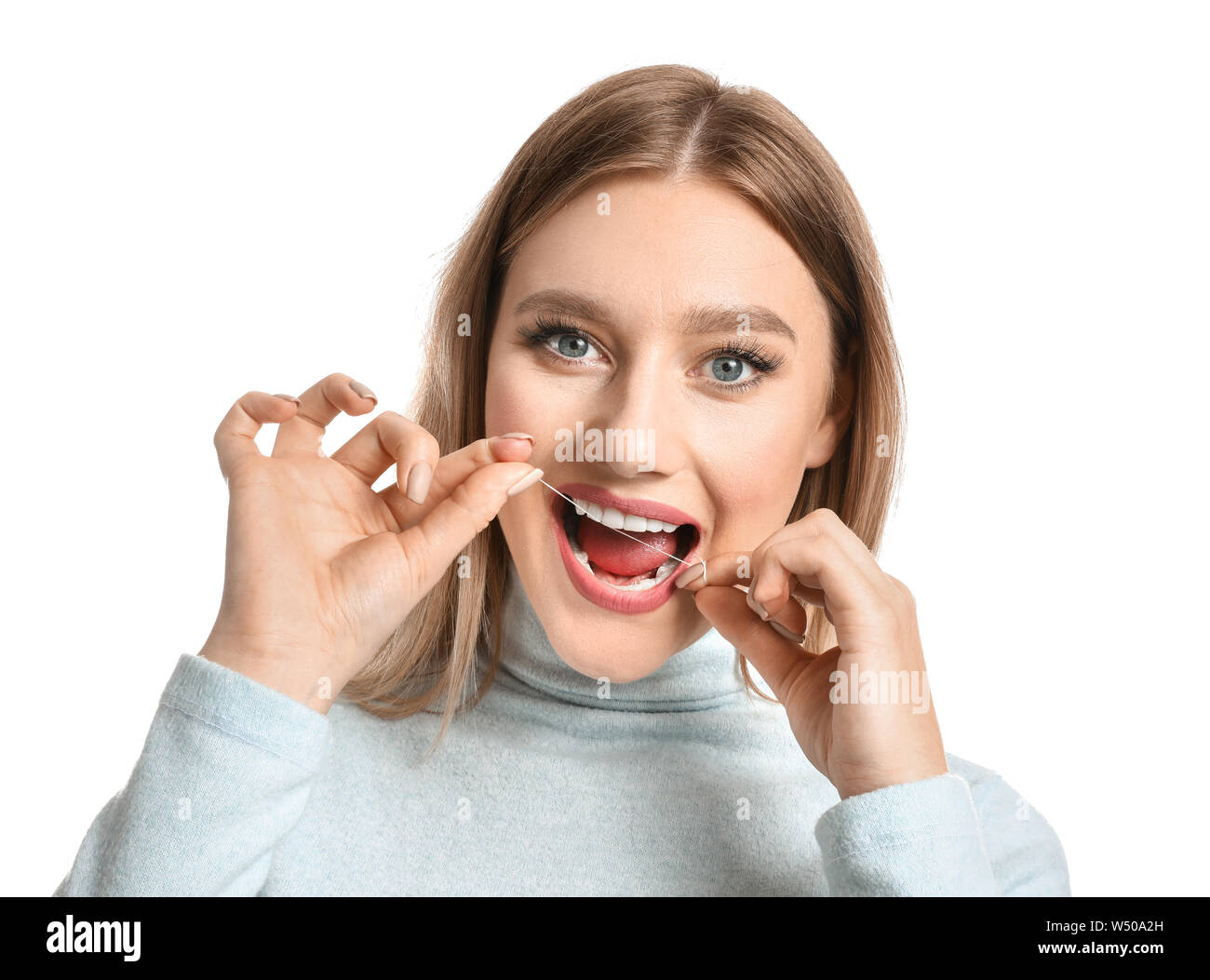 Woman flossing teeth on white background Stock Photo - Alamy