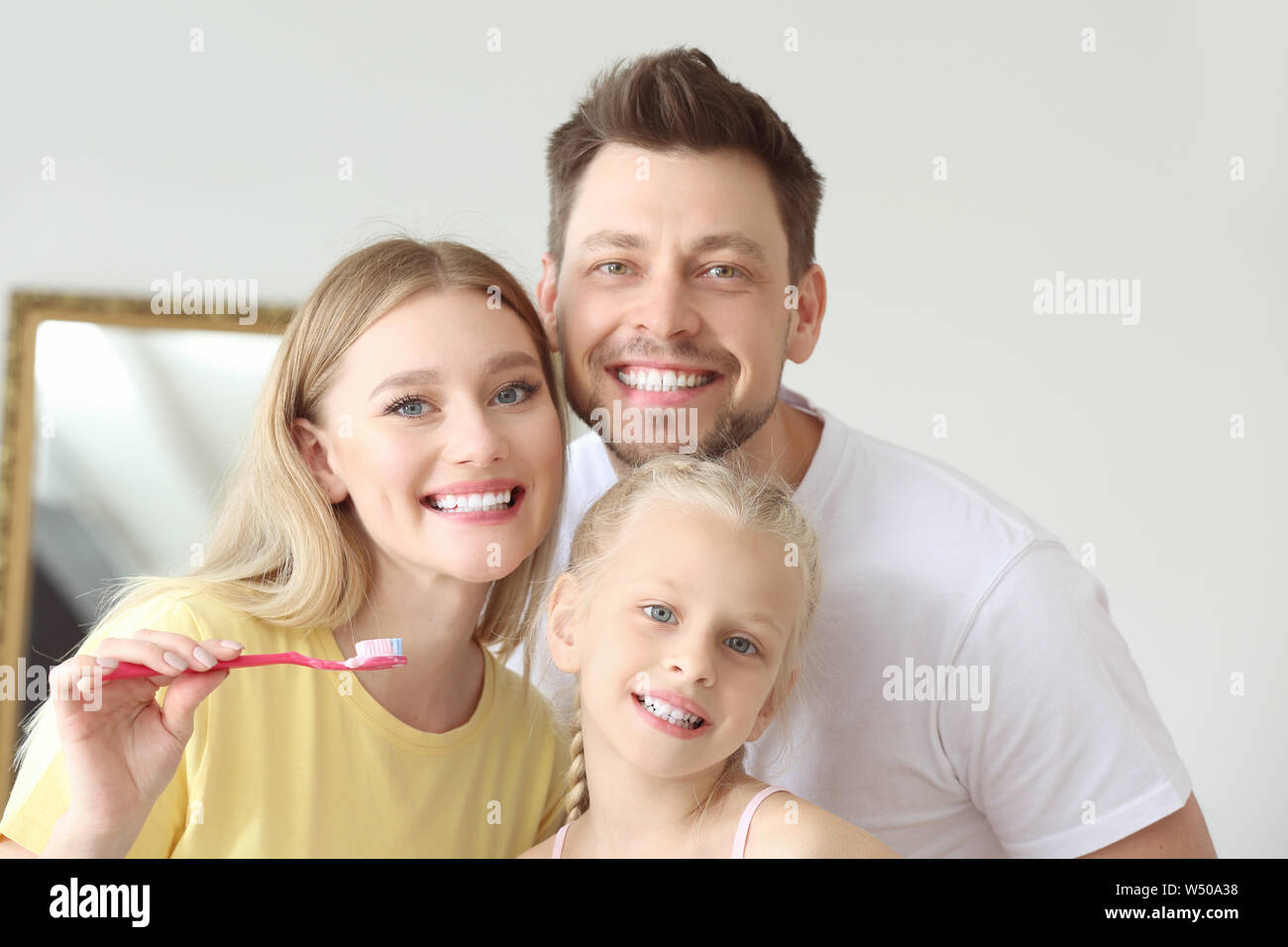 Family cleaning teeth at home Stock Photo - Alamy