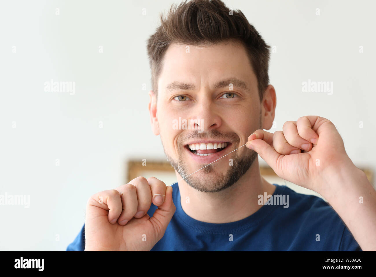 Man flossing teeth at home Stock Photo - Alamy
