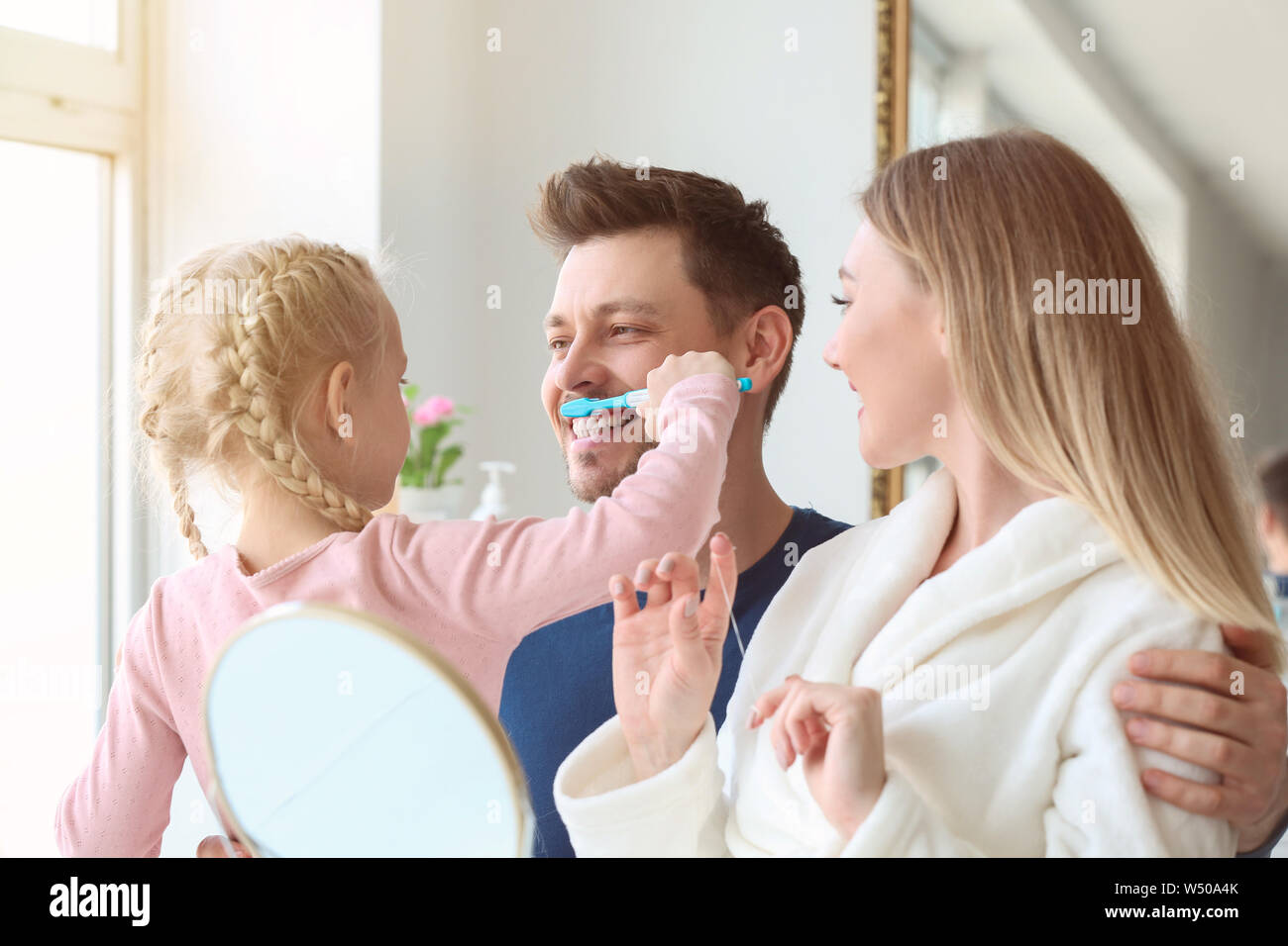 Family cleaning teeth at home Stock Photo - Alamy