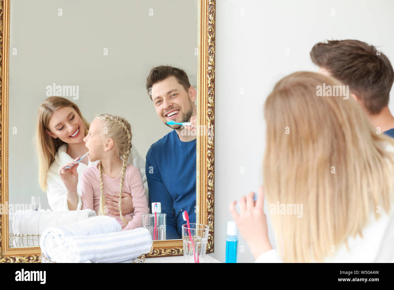 Family cleaning teeth at home Stock Photo - Alamy