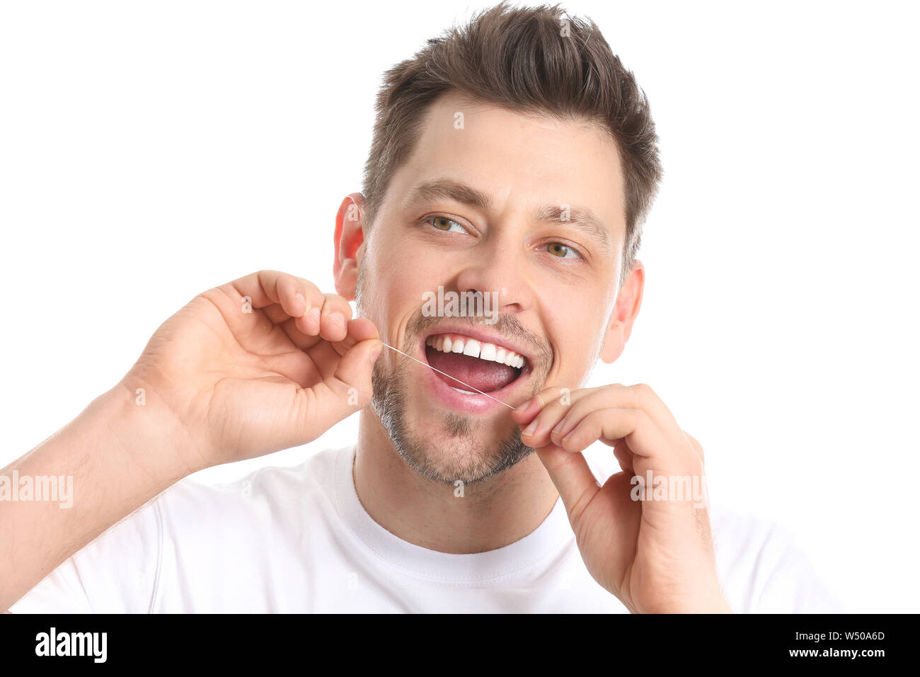 Man flossing teeth on white background Stock Photo - Alamy
