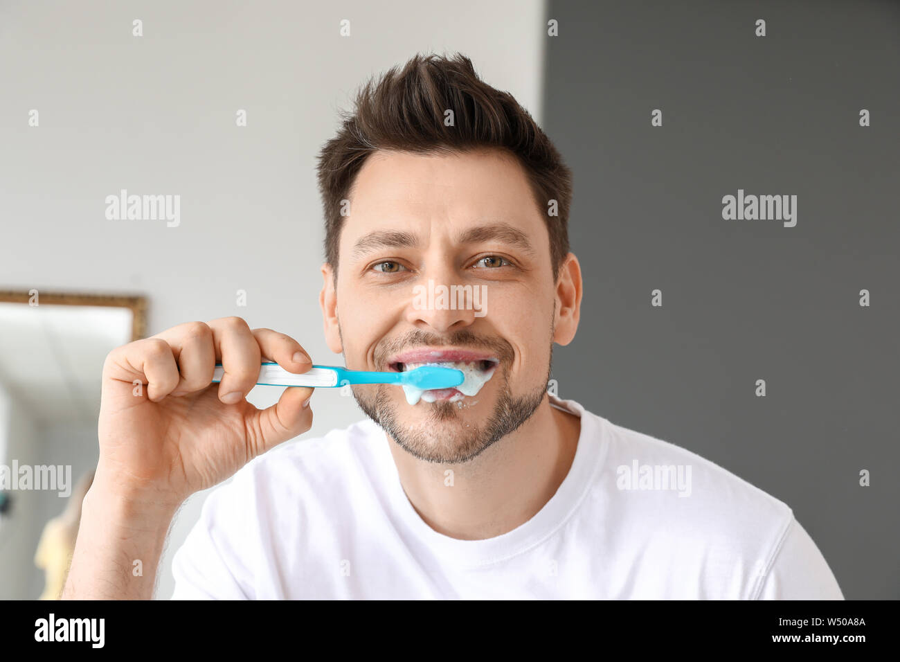Man cleaning teeth at home Stock Photo - Alamy