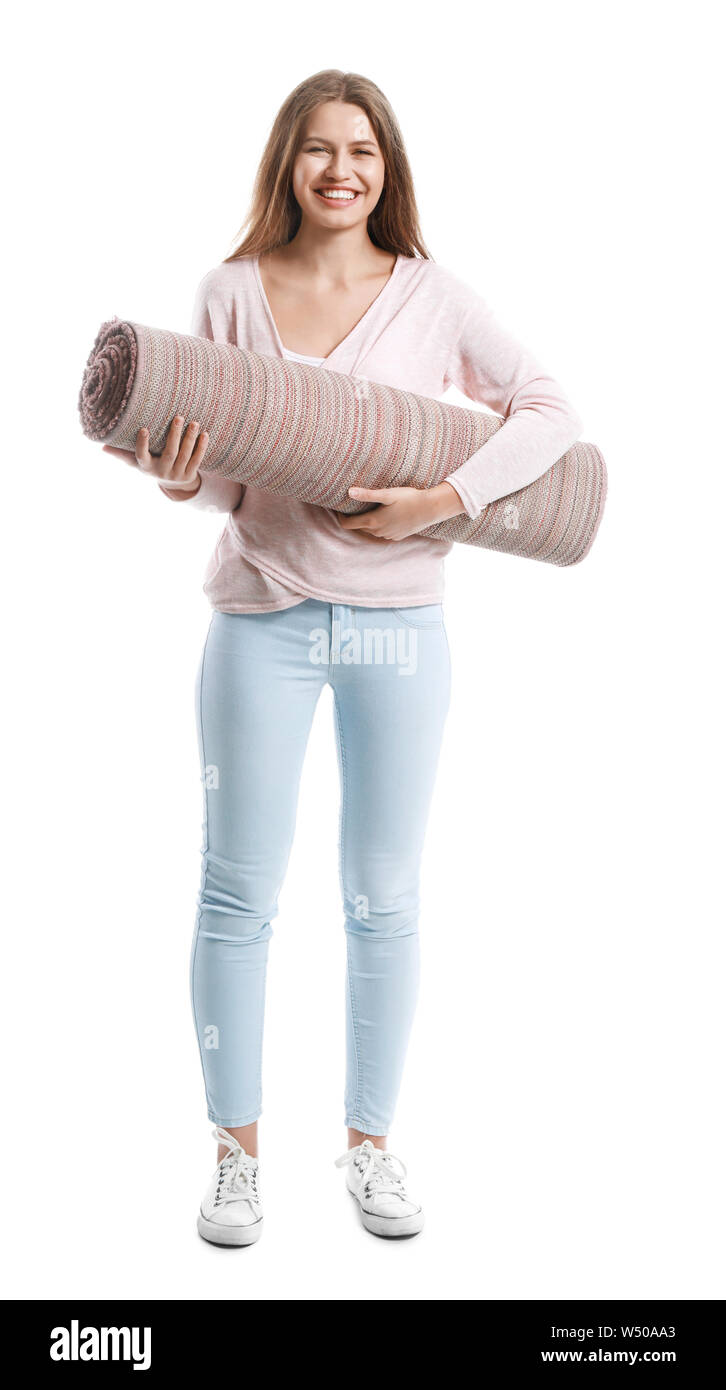Young woman holding rolled carpet against white background Stock Photo ...