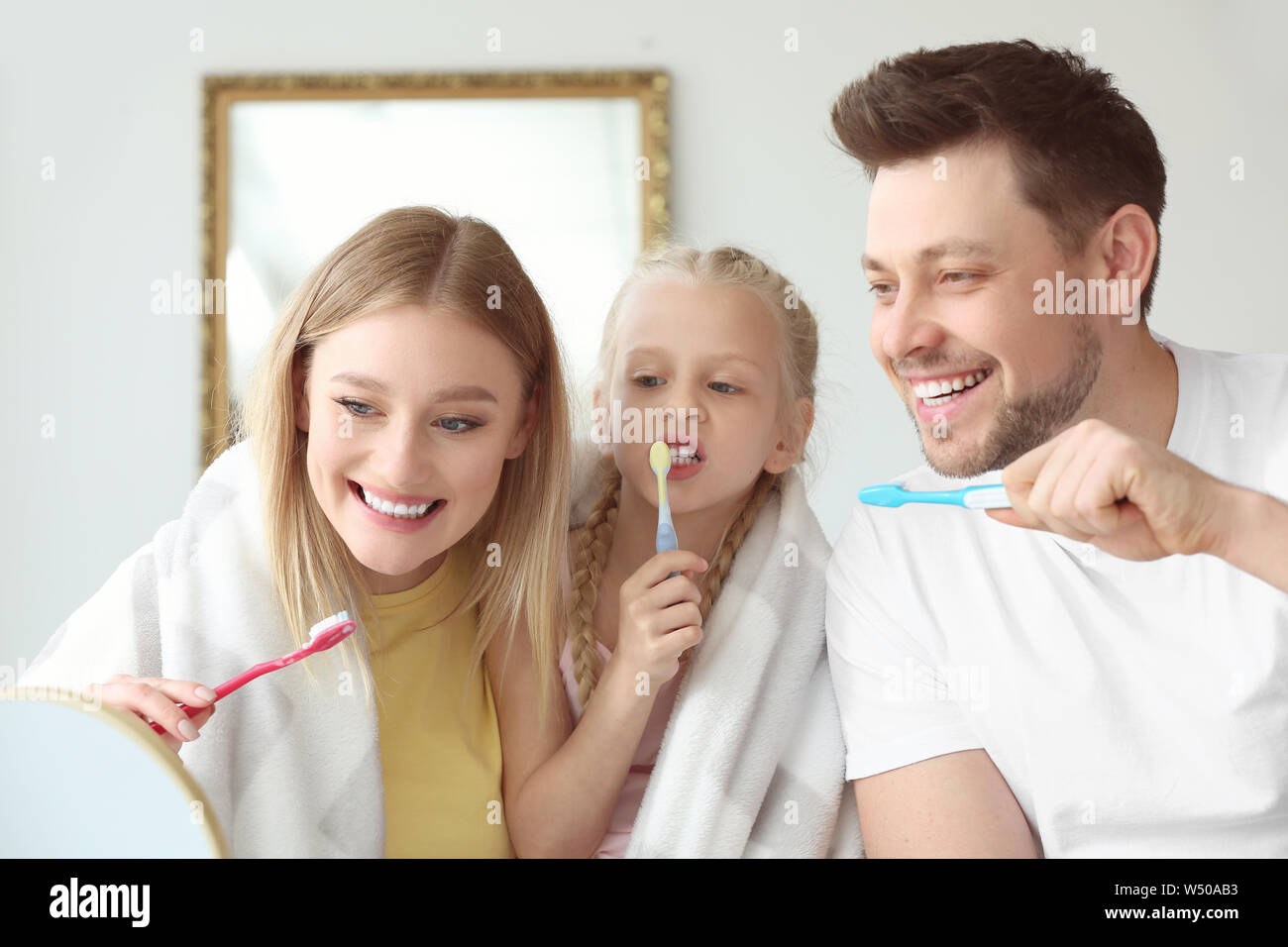 Family cleaning teeth at home Stock Photo - Alamy