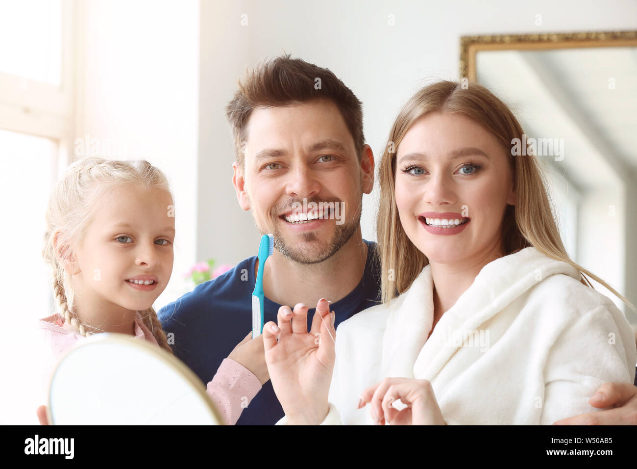 Family cleaning teeth at home Stock Photo - Alamy