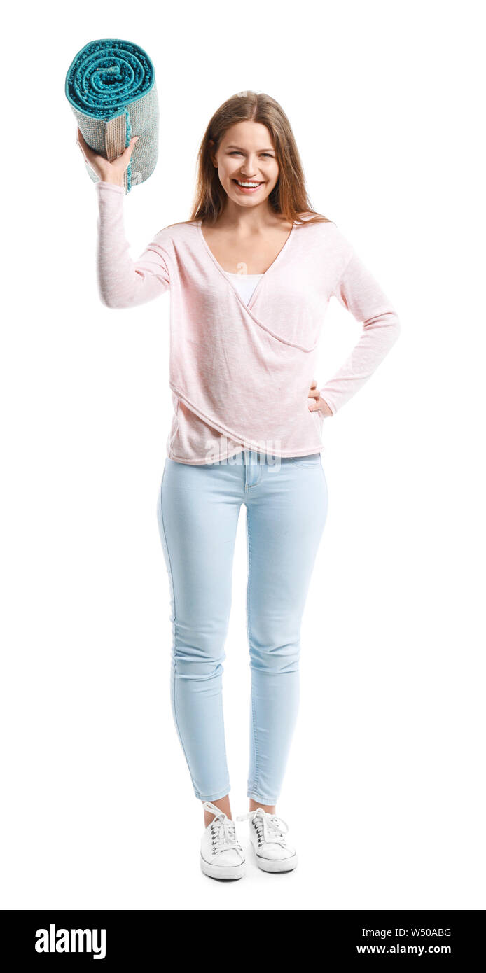 Young woman holding rolled carpet against white background Stock Photo ...