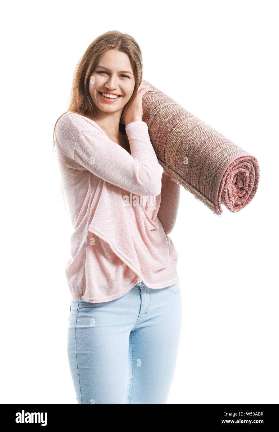 Young woman holding rolled carpet against white background Stock Photo ...