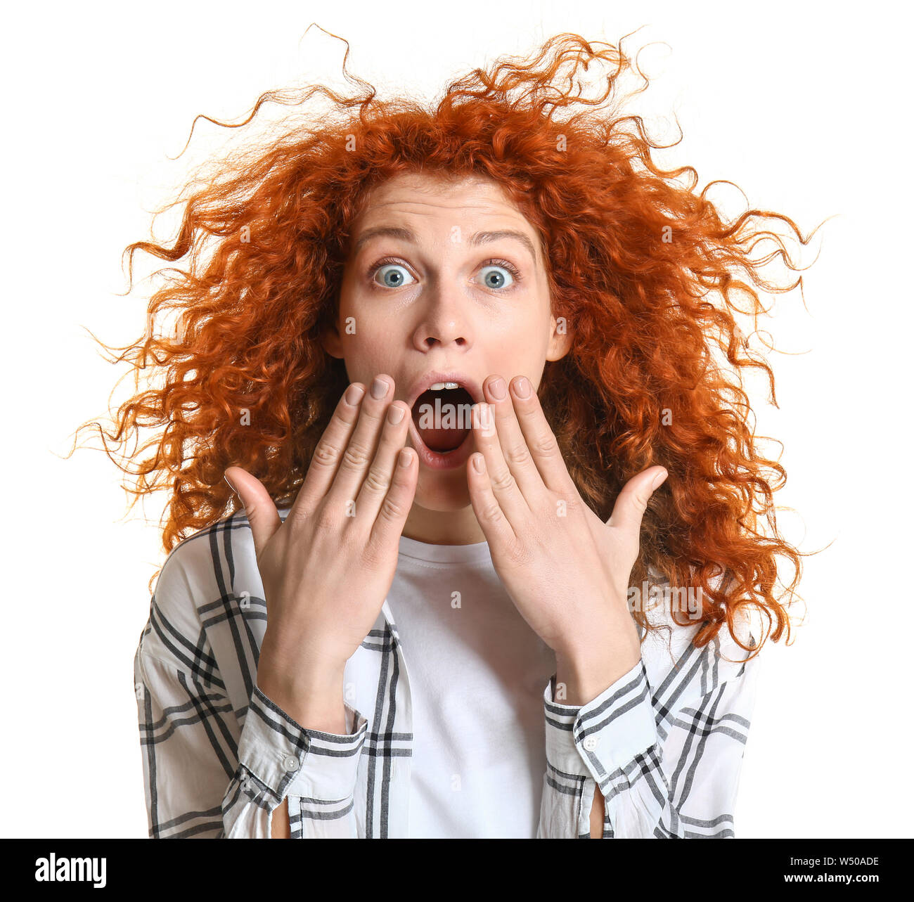 Shocked redhead woman on white background Stock Photo - Alamy