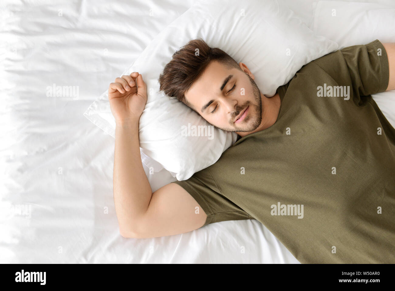 Handsome man sleeping in bed hi-res stock photography and images - Alamy