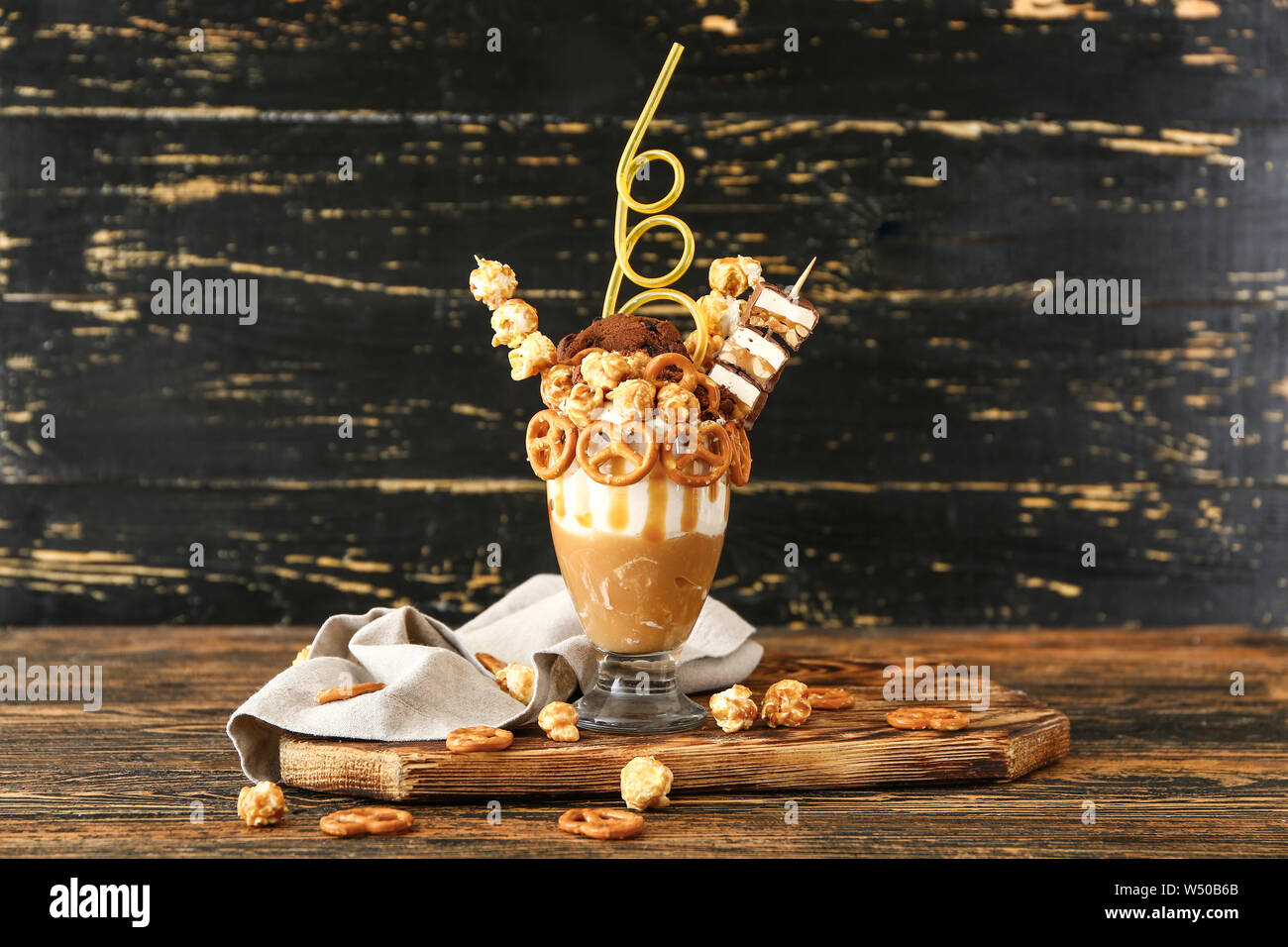 Glass with delicious freak shake on wooden table Stock Photo - Alamy