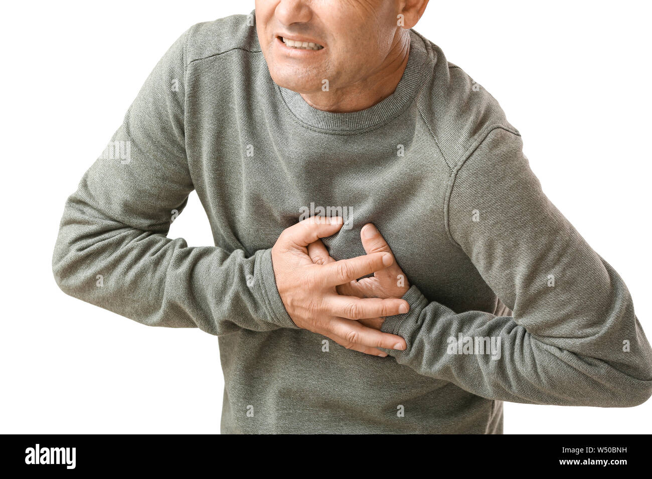 Mature man suffering from heart attack on white background Stock Photo ...