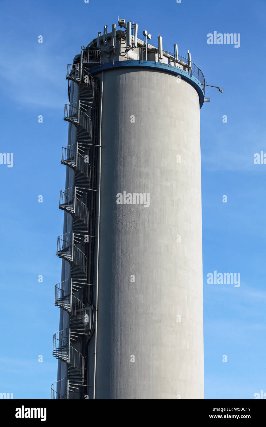 Concrete industrial silo tower under blue sky Stock Photo - Alamy